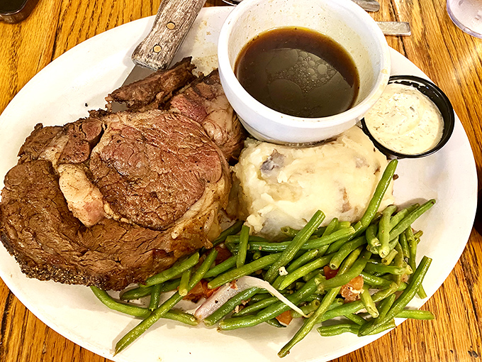 Prime rib so tender it practically surrenders to your fork, accompanied by mashed potatoes and green beans that didn't come from a can.