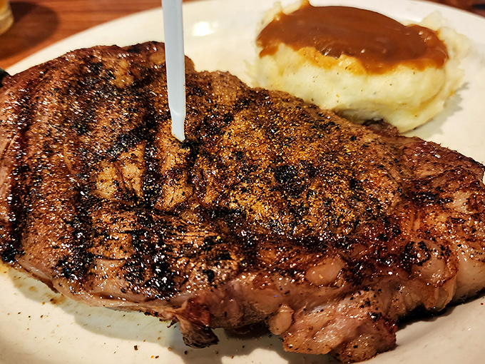 A perfectly seasoned steak with a side of mashed potatoes drowning in gravy. This plate doesn't just feed you; it hugs your soul.