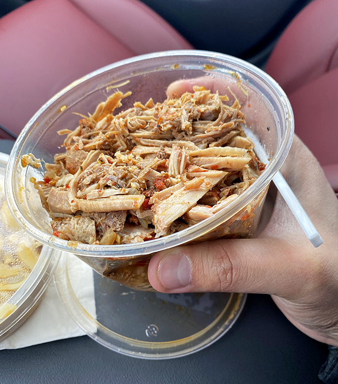 Pulled pork so tender it practically shreds itself, with just enough bark mixed in to remind you this is serious barbecue business.