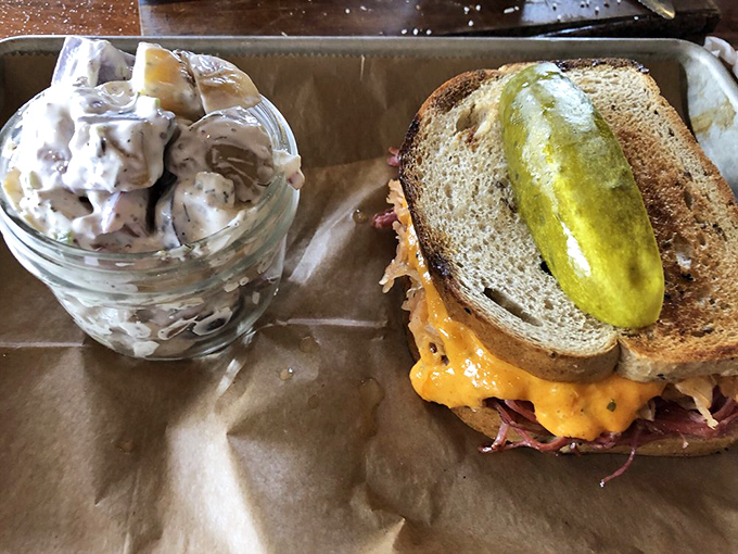 The Reuben sandwich stands proud with a pickle spear crown&mdash;a perfect marriage of corned beef, sauerkraut, and melty cheese that demands both hands and zero shame.