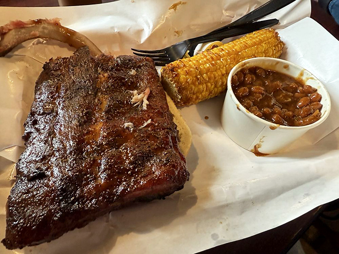 That smoke ring doesn't lie. Pappy's ribs showcase the telltale pink halo that separates amateur smoking from the pros. Those beans aren't just sidekicks.