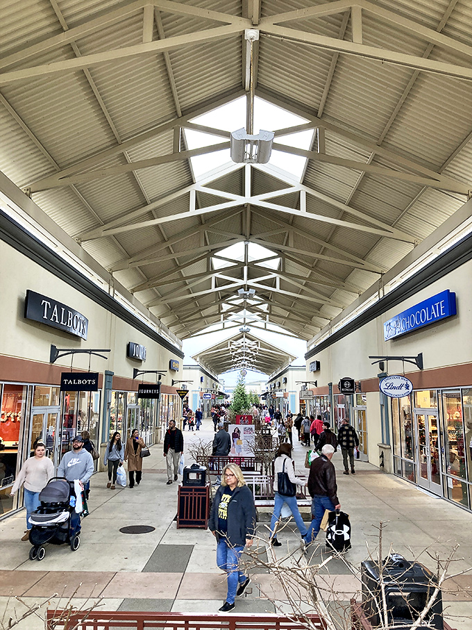 The cathedral-like ceiling draws the eye upward, but let's be honest &ndash; your gaze is locked on those Talbots and Lindt Chocolate signs like a heat-seeking missile.