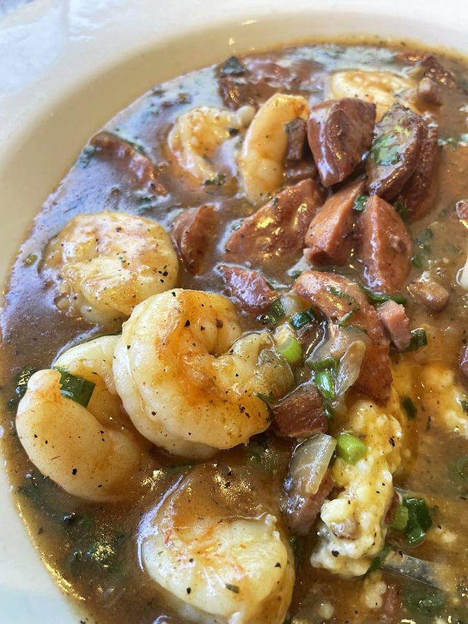 A closer look reveals the magic&mdash;perfectly cooked shrimp nestled against creamy grits, with that gravy demanding to be savored to the last drop.