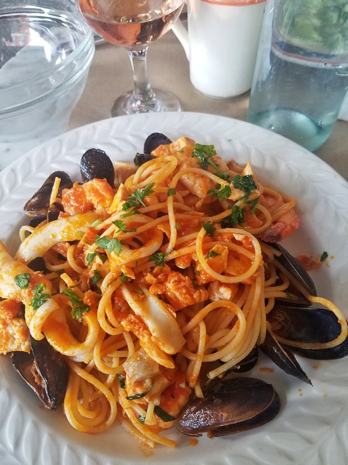 The seafood pasta arrives like an aquatic reunion, where mussels, calamari and tomato sauce have gathered to throw the best party your taste buds have attended all year.