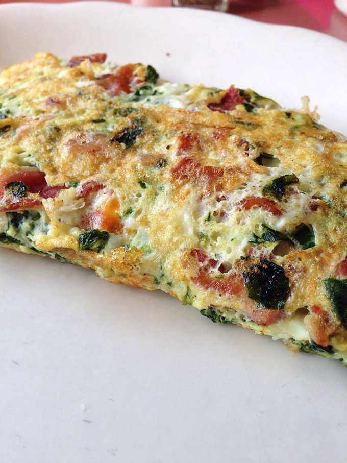 This isn't just any omelet&mdash;it's what happens when vegetables and cheese decide to throw a morning party on your plate.