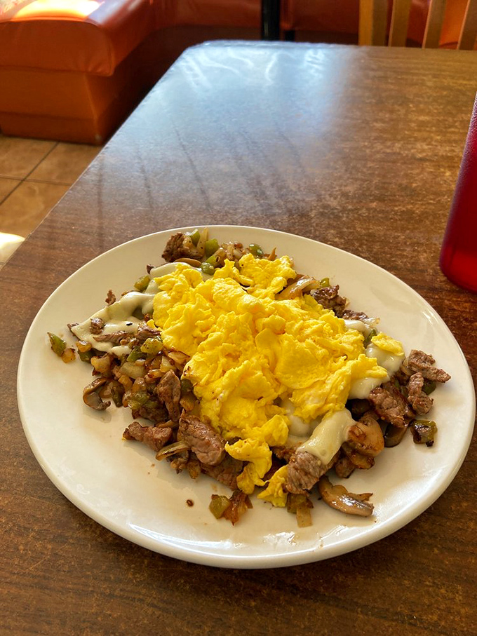 A mountain of seasoned steak hash topped with perfectly yellow eggs. This plate doesn't just say good morning&mdash;it shouts it from the rooftops.