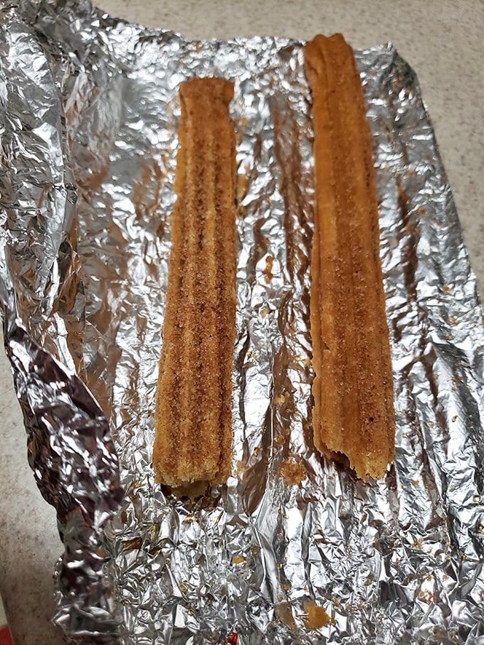 Two churros on foil&mdash;simple, unadorned, and absolutely magnificent. Like meeting Paul Newman in a bathrobe at the grocery store&mdash;casual yet unforgettable.