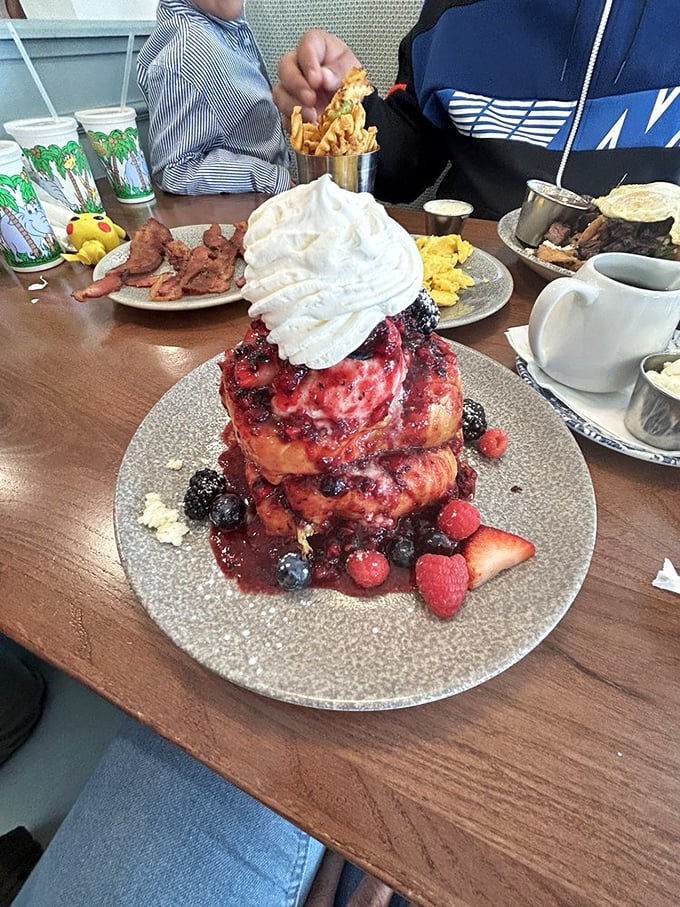 The Berry Yogurt French Toast in all its glory &ndash; a tower of brioche crowned with fresh berries and whipped cream that's breakfast and dessert in one glorious package.