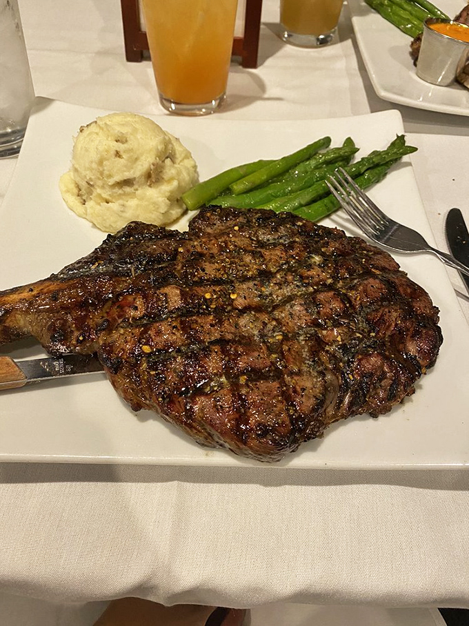 The cowboy ribeye arrives with the confidence of John Wayne&mdash;commanding the plate with a supporting cast of mashed potatoes and vibrant asparagus.