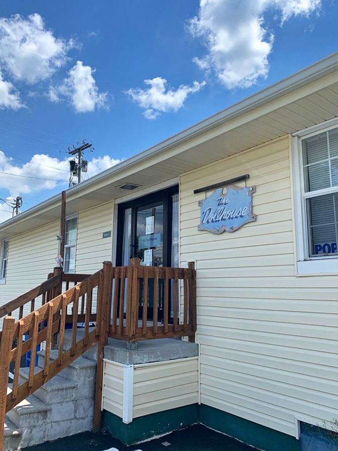The Dollhouse wears its blue sign proudly against cream siding - a humble exterior that belies the treasures waiting inside this off-the-beaten-path gem.