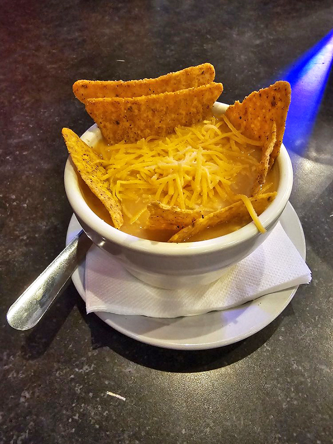 Not your average tortilla soup! Topped with crispy tortilla triangles pointing skyward like UFOs hovering over a cheesy galaxy.