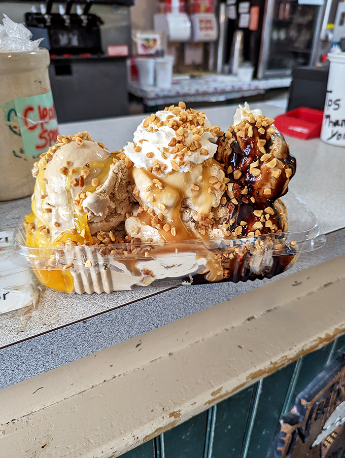 Three scoops, three sauces, and enough peanuts to make an elephant blush. This isn't dessert&mdash;it's a commitment to excellence.