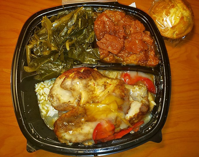 A symphony on a plate: tender chicken, vibrant collard greens, and saucy yams that would make your grandmother both jealous and proud.