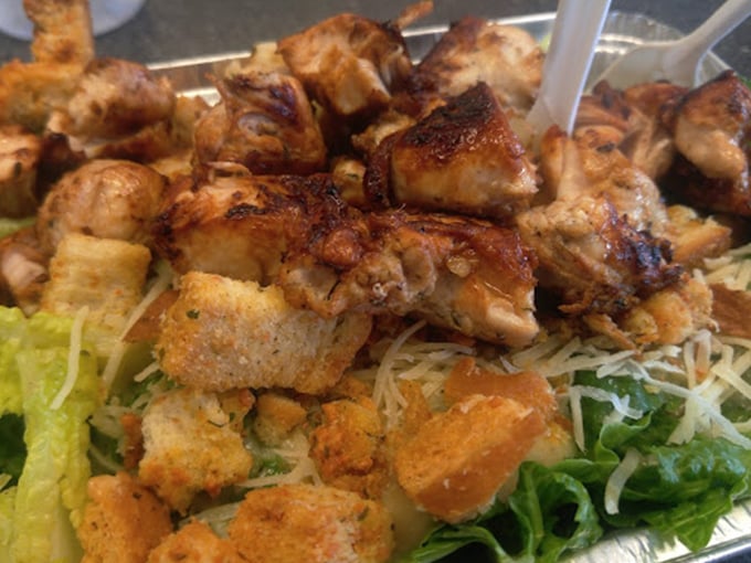 Protein paradise! Those perfectly grilled chicken chunks are doing a delicious dance with the croutons on a bed of greens that actually deserves to be eaten.