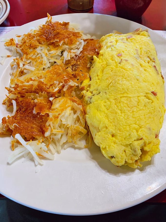 This isn't just an omelet &ndash; it's an architectural achievement. The vibrant yellow exterior houses a treasure trove of fillings that would make Fort Knox jealous.
