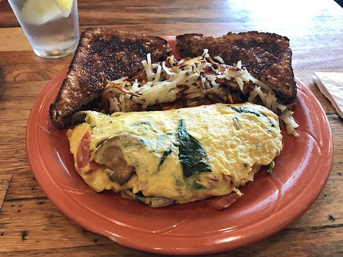 This omelet doesn't just contain vegetables; it celebrates them. Paired with hash browns so crispy they practically applaud when your fork arrives.