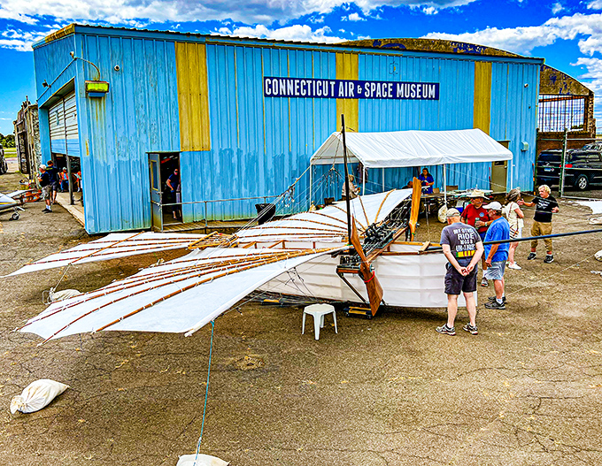 Outside the blue hangar sits a replica early aircraft that would make the Wright brothers proud. Aviation's humble beginnings on display for curious visitors.