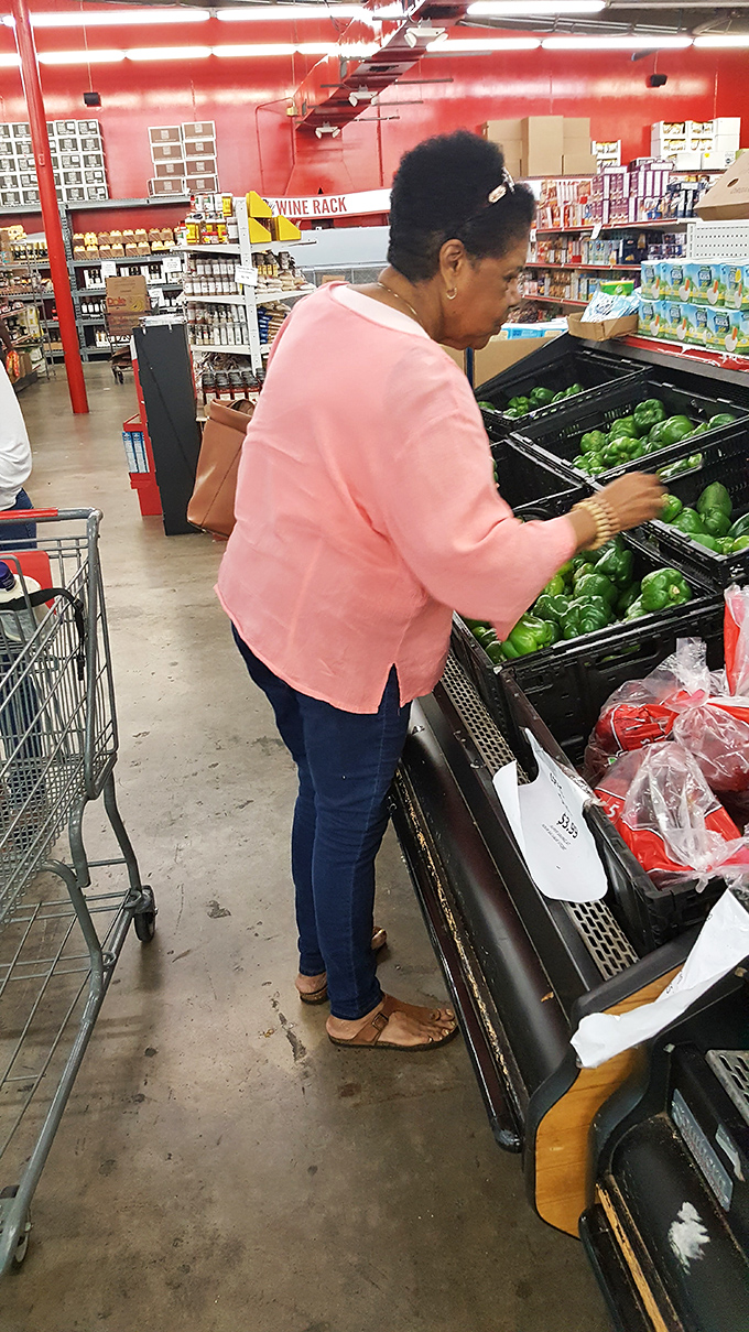 Shoppers carefully selecting the freshest produce&mdash;proving that bargain hunting and quality ingredients aren't mutually exclusive culinary concepts.