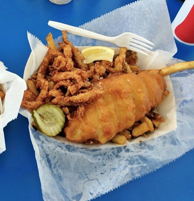 The holy trinity of comfort food: golden fish, crispy clams, and hand-cut fries. Add a pickle for that perfect acidic counterpoint.