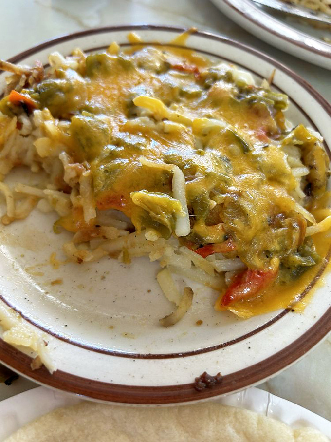 Green chile and melted cheese transform ordinary hash browns into an extraordinary New Mexican masterpiece that haunts your dreams.