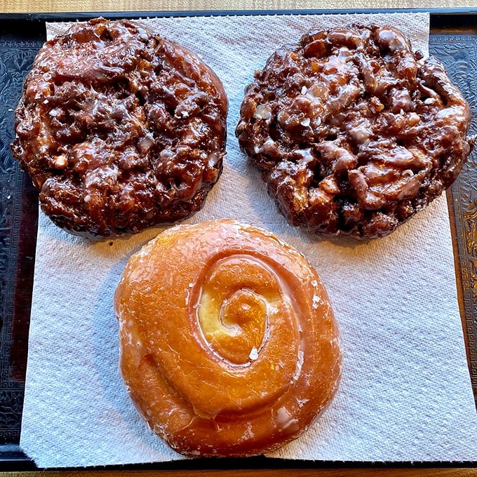 The holy trinity of breakfast indulgence: two apple fritters and a cinnamon roll. Diets, beware &ndash; resistance is futile!