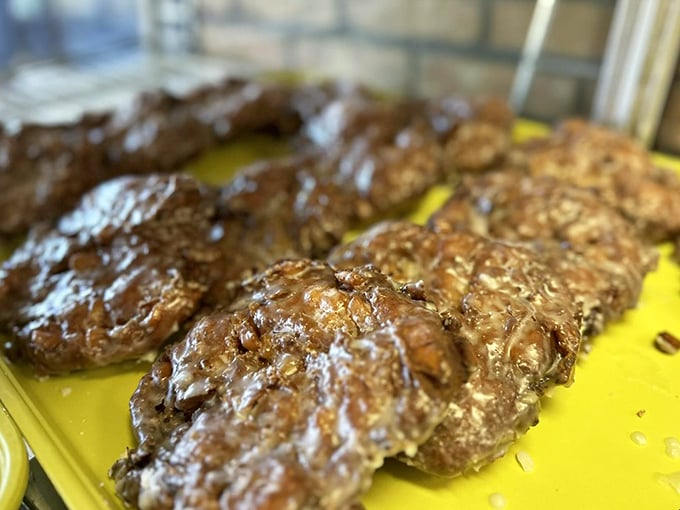 Behold the chocolate-glazed lineup, glistening under the display lights like Olympic medals for your taste buds.