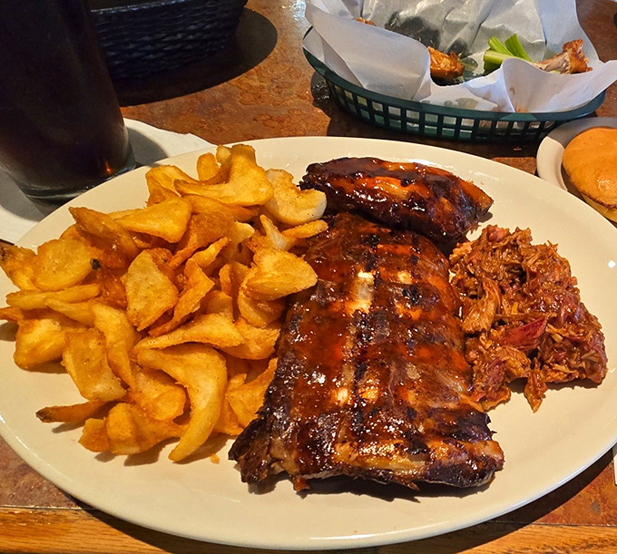 The perfect trifecta&mdash;glistening ribs, golden chips, and pulled pork that looks like it's been slow-dancing with barbecue sauce all day long.