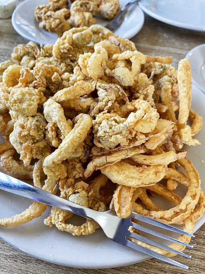 A mountain of fried clams and onion rings that would make Neptune himself put down his trident and pick up a fork.