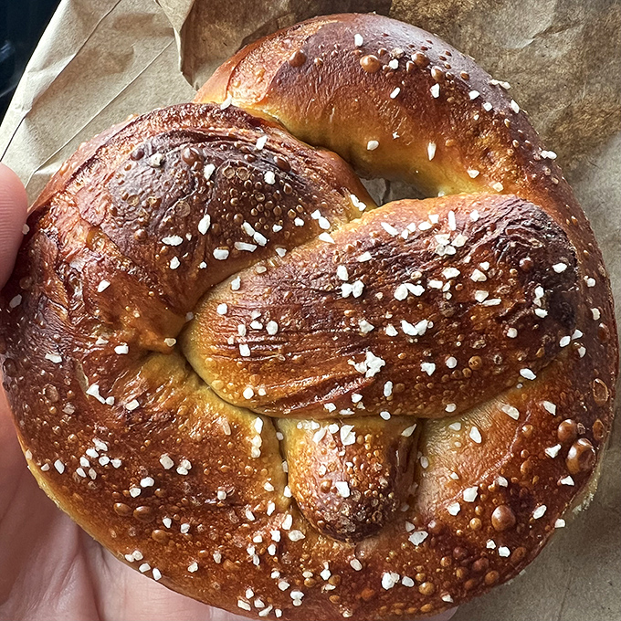 A raw pretzel dough creation awaits its transformation. Like Michelangelo seeing David in marble, the bakers see twisted perfection in simple flour and water.