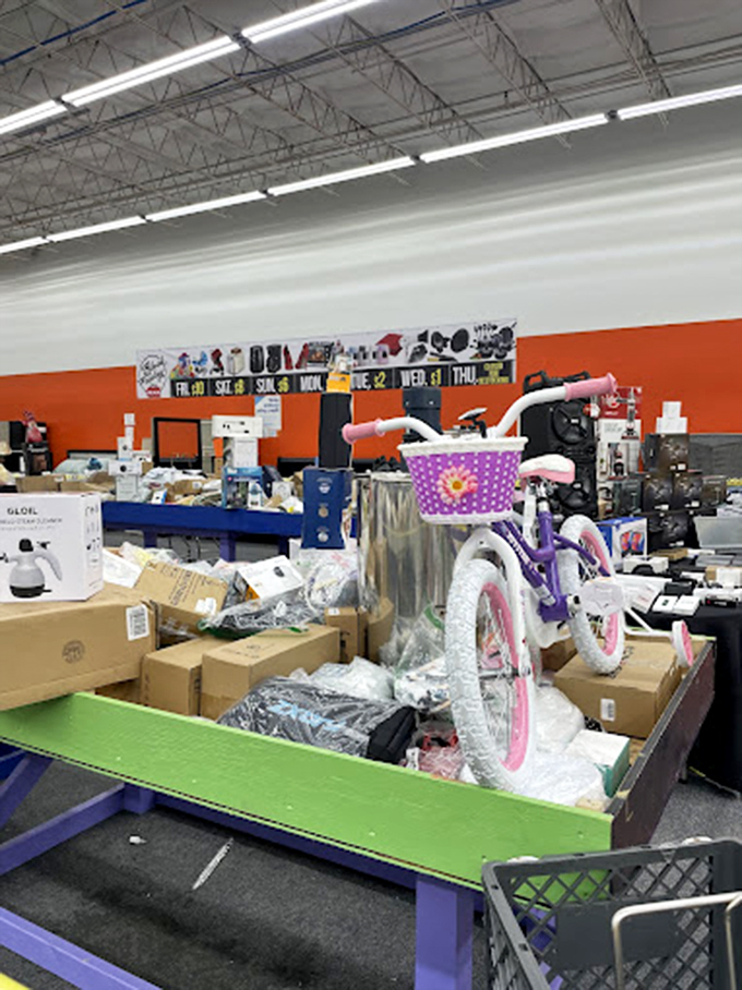 A child's dream come true! This purple bike with its cheerful basket sits proudly among the chaos, waiting for its next adventure.