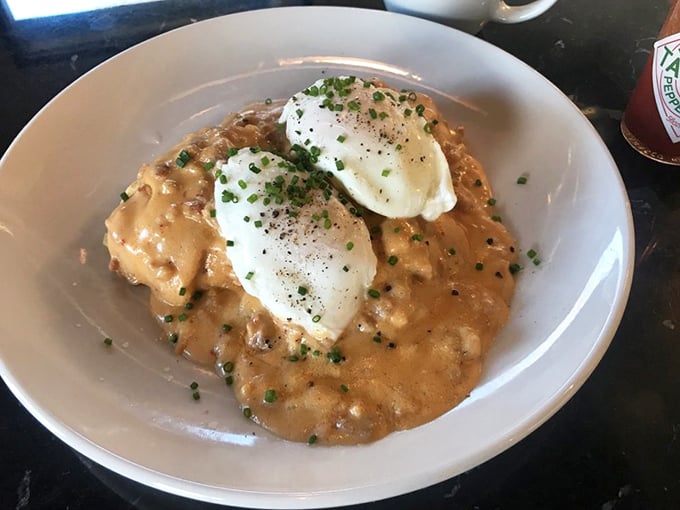 Biscuits and gravy reimagined—poached eggs floating atop a sea of savory goodness. This is comfort food that gives you an actual hug.