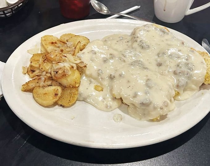 Biscuits and gravy that would make your Southern grandmother weep with joy – a creamy, savory blanket covering everything in its path.