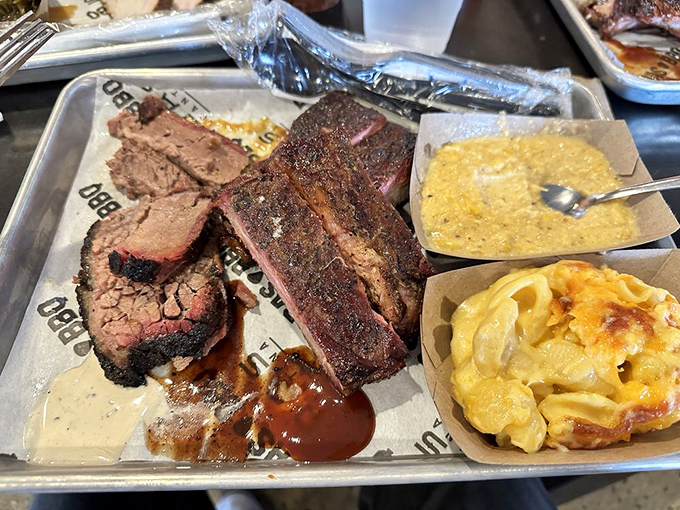 A carnivore's dream plate featuring tender brisket and fall-off-the-bone ribs with creamy, dreamy sides.