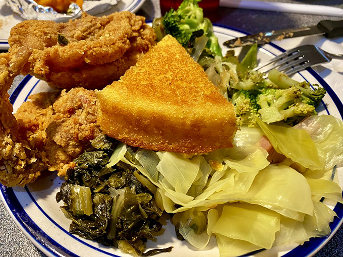 The plate that answers life's eternal question: "Why choose one side when you can have five?" Collard greens and fried goodness&mdash;a balanced diet by buffet standards.