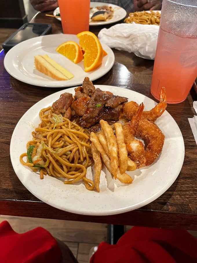 The perfect buffet strategy on display: protein, carbs, and fried delights in harmonious balance. That pink drink is the cherry on top of this feast symphony.