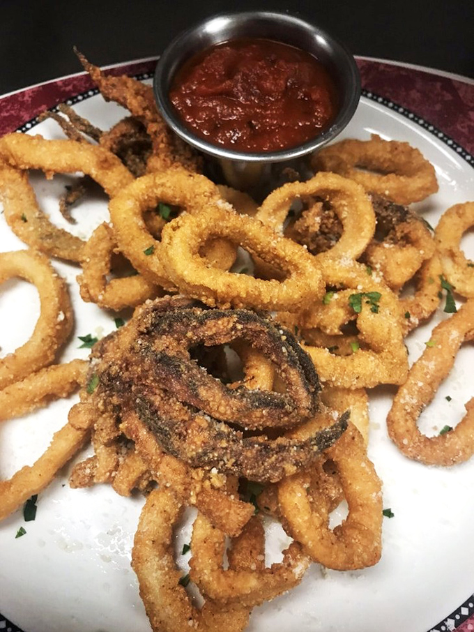 Crispy calamari rings stacked like delicious little life preservers in a sea of marinara. Whoever first decided to bread and fry these deserves a Nobel Prize.