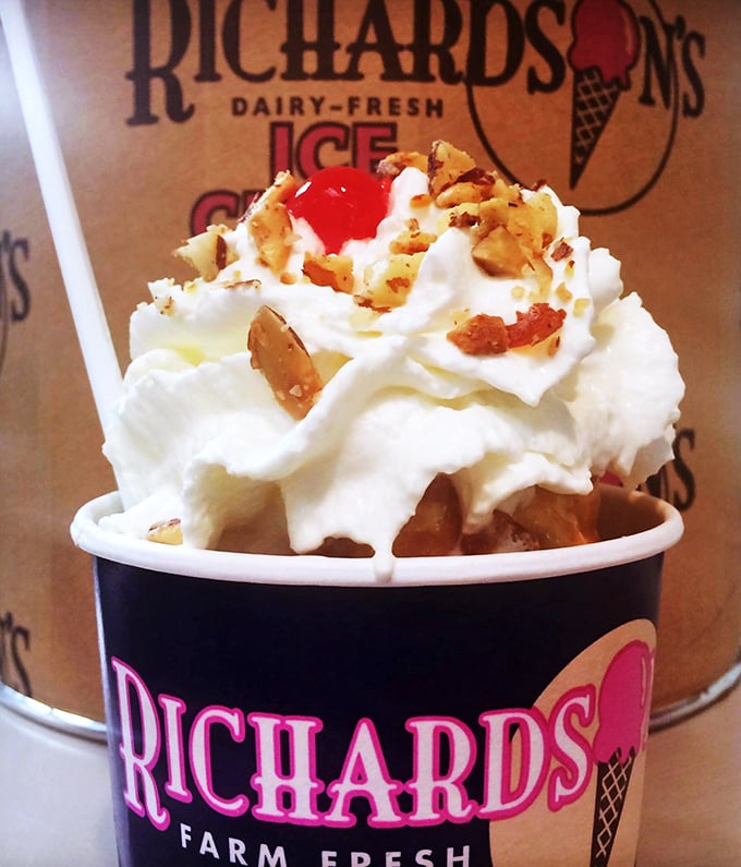 A towering masterpiece of soft serve adorned with nuts and a cherry, proving that sometimes the best architecture in Massachusetts involves dairy.