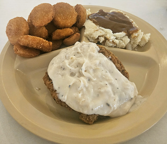 The star of the show: chicken fried steak under a blanket of pepper gravy with fried okra and mashed potatoes. Diet starts tomorrow!