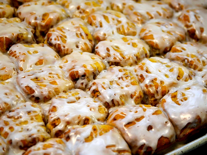 Heaven exists, and it looks like this tray of freshly glazed cinnamon rolls waiting to fulfill their destiny as the highlight of your day.
