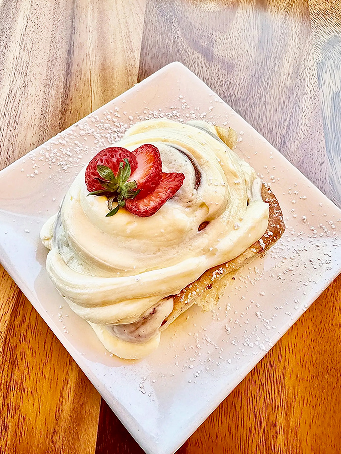 Poetry on a plate: this cinnamon creation with its crown of cream cheese frosting and perfect strawberry garnish might just bring tears to your eyes.