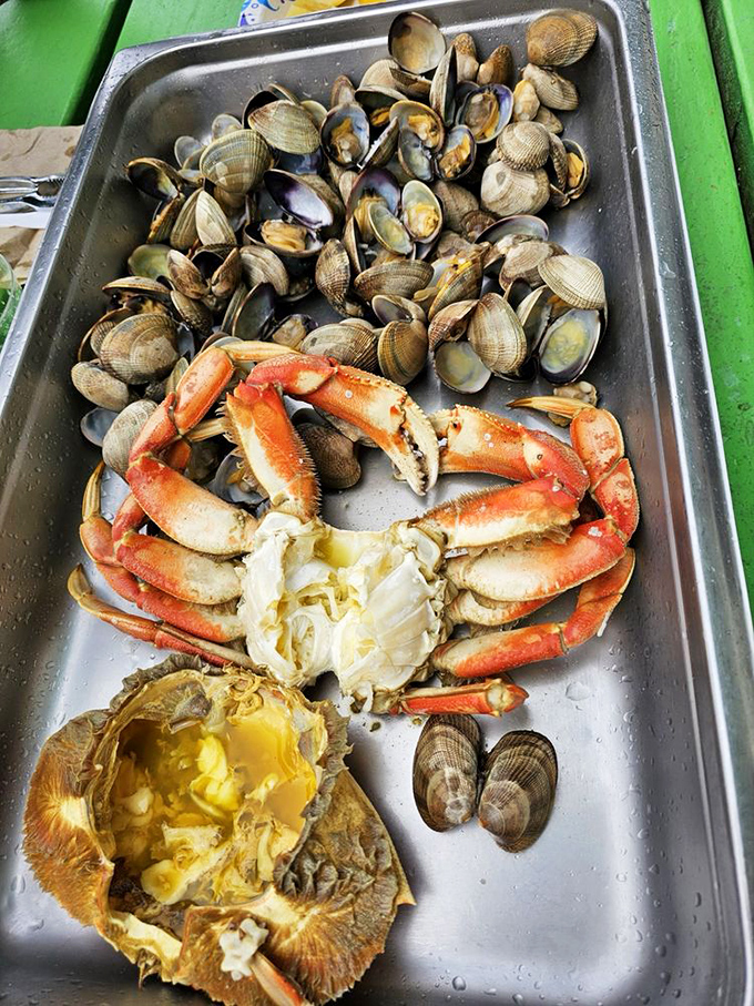 The seafood trifecta&mdash;crab, clams, and oysters sharing a tray like old friends at a reunion. The ocean's finest, ready for your plate. 