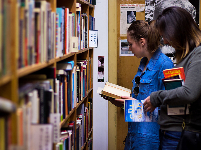 The universal posture of book lovers everywhere: slightly hunched, completely absorbed, and utterly oblivious to the passage of time or approaching closing hours.