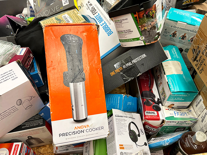 Digging through these bins feels like archaeology for the modern bargain hunter—that Anova precision cooker buried under headphones could be your kitchen game-changer.