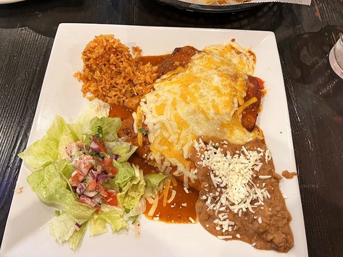 The holy trinity of Mexican dining: perfectly melted cheese, vibrant sauce, and a side of rice that actually deserves plate space. This isn't a meal&mdash;it's edible artwork. 