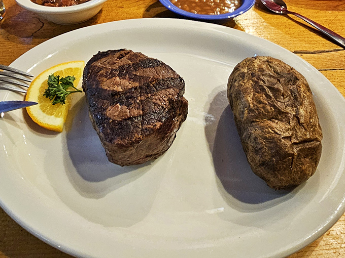 Simplicity at its finest: a perfectly cooked filet mignon alongside a baked potato. No foam, no tweezers, no nonsense&mdash;just pure carnivorous joy.