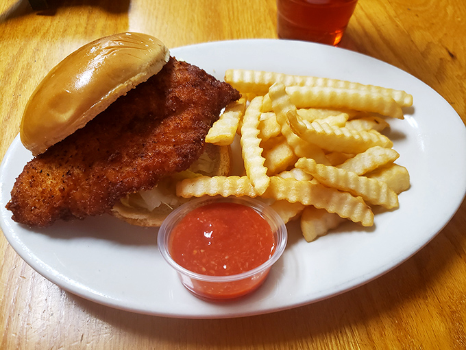 Some places hide skimpy portions under fancy garnishes. At Sting-Ray's, the fish is the showstopper &ndash; hanging over the bun like it's making a statement about generosity.