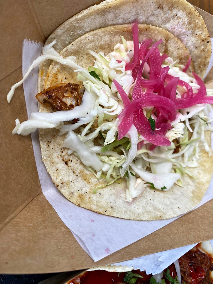 A fish taco that deserves its own maritime holiday. That pickled red onion adds the kind of zing that makes your taste buds stand up and salute.