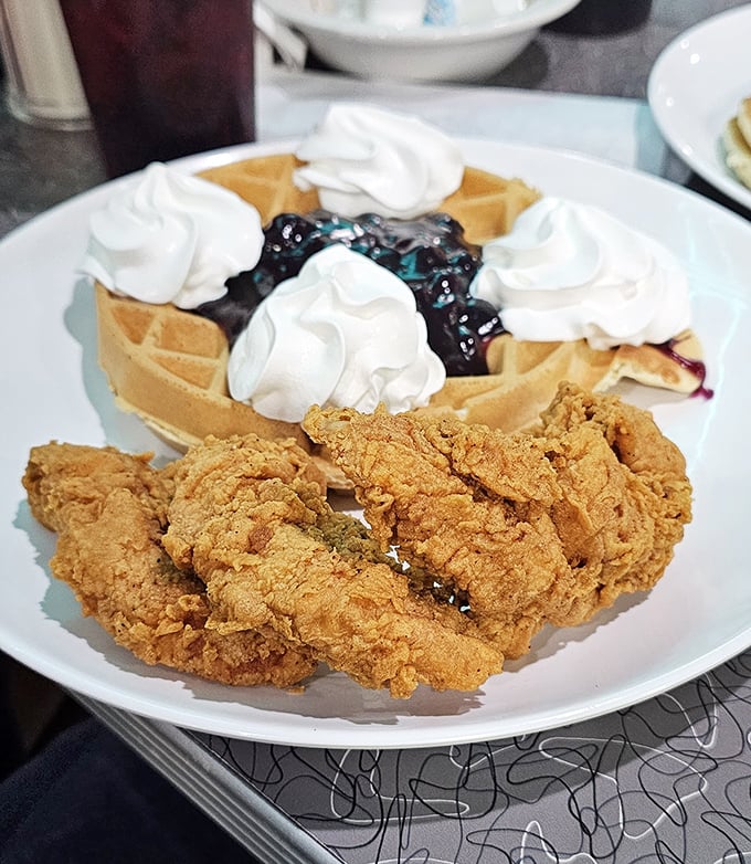 Who says you can't have it all? Golden-fried chicken meets sweet waffle topped with blueberries and whipped cream&mdash;a breakfast rebellion worth joining.