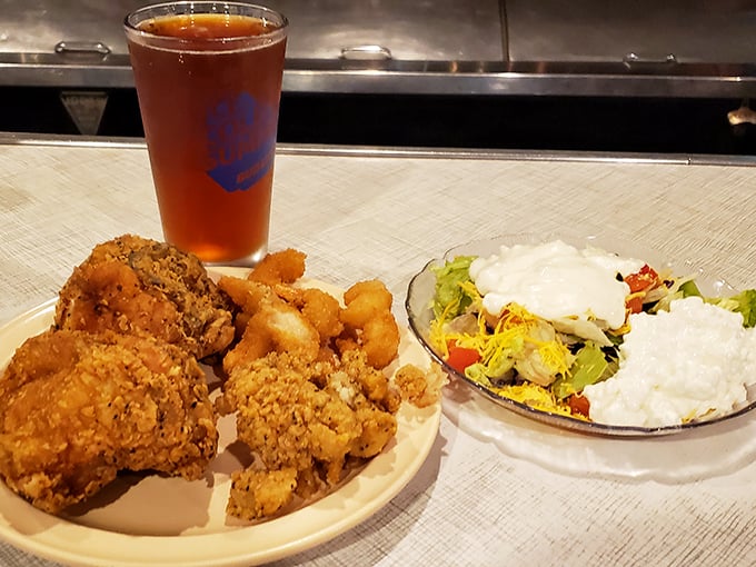 Fried chicken that would make Colonel Sanders weep with jealousy, paired with a garden-fresh salad and sweet tea in a proper pint glass.