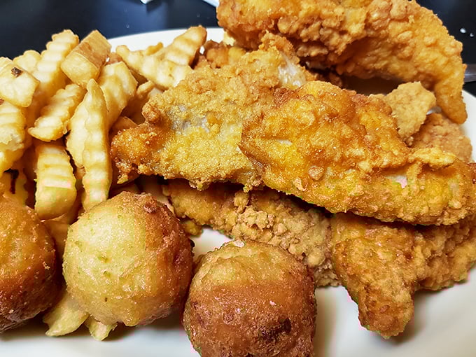The holy trinity of Southern comfort: perfectly fried fish, golden hushpuppies, and crinkle-cut fries&mdash;a plate that speaks the universal language of satisfaction.